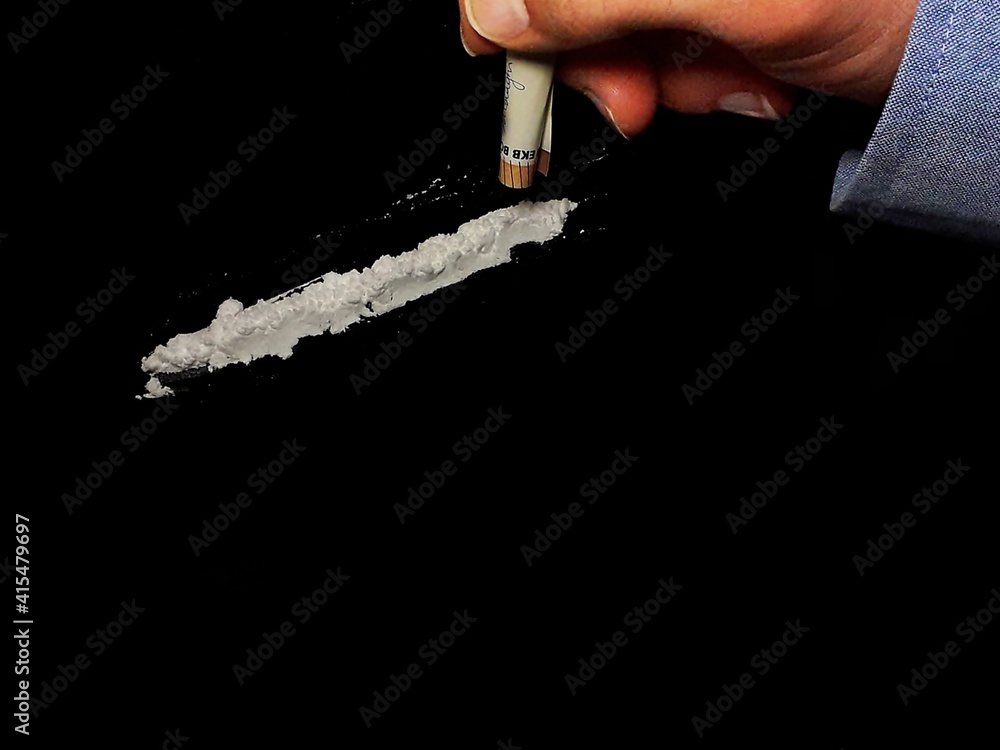 Businessman use 50 euro banknote to snorting cocaine drug powder lines ...