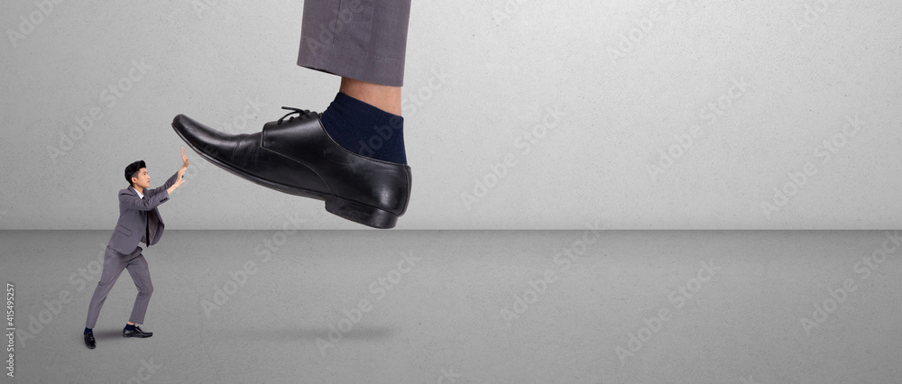 Foot of leader or boss with authority huge trample on frightened ...