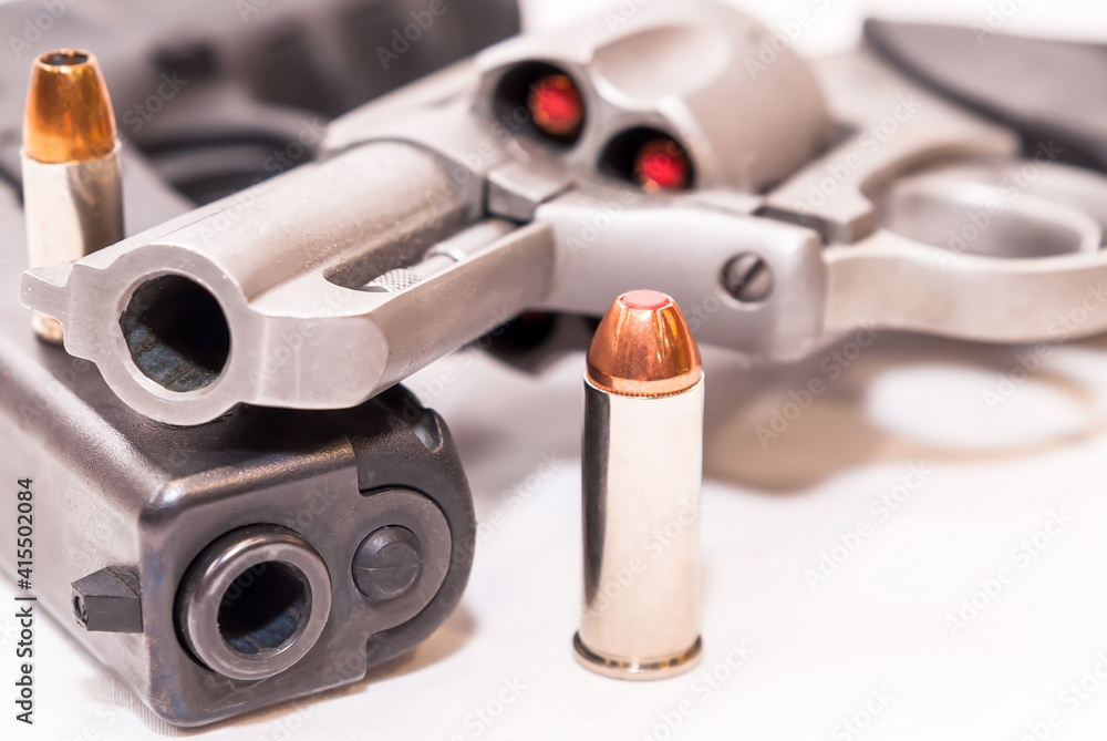 Two handguns, a black 9mm pistol and a stainless 44 spl revolver loaded ...