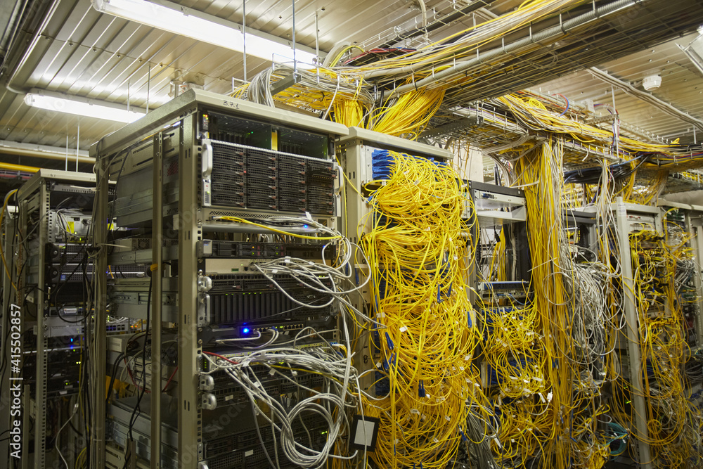 Foto de Background image of messy server room with internet cables and ...