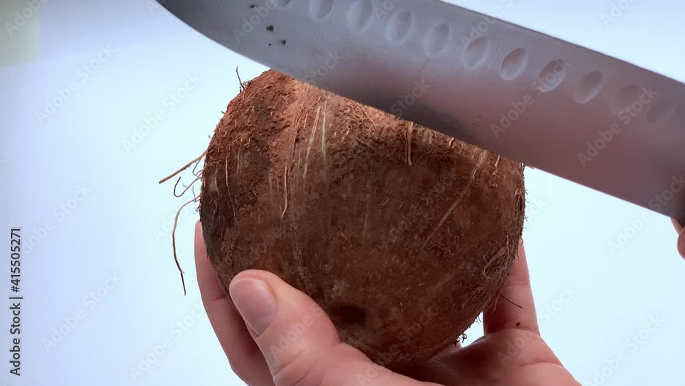 How to peel coconut at home using Knife. A woman peels the skin of a ...