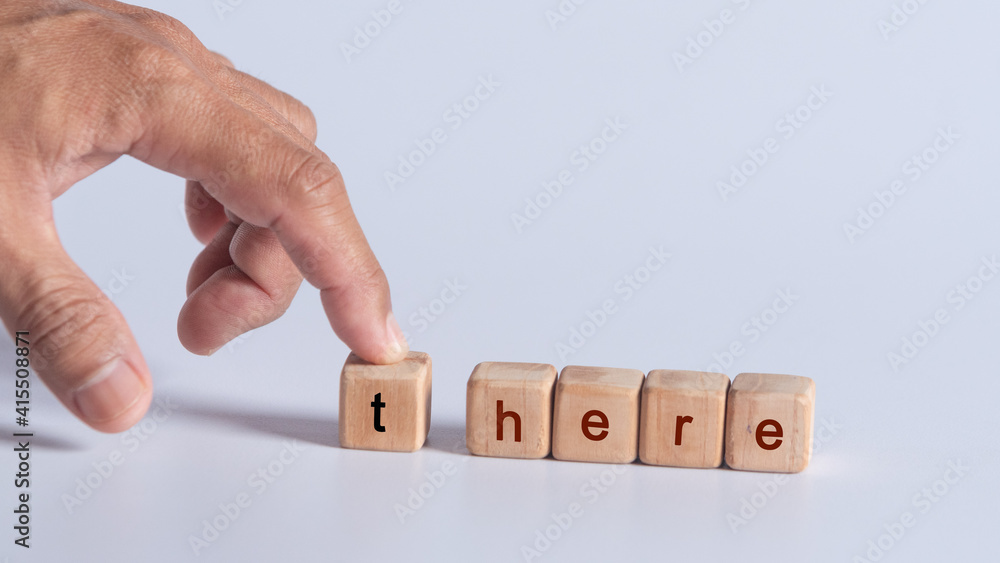 hand holding dice with text for illustration of "there and here" words ...
