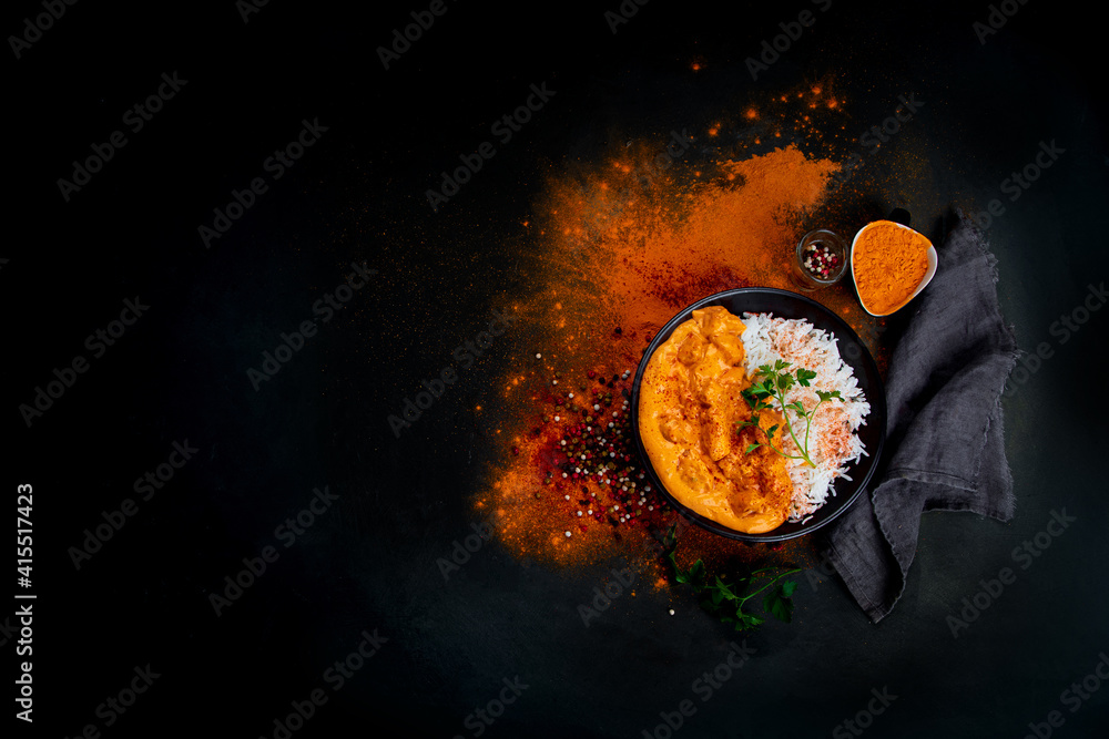 Indian butter chicken curry with basmati rice on dark background ...