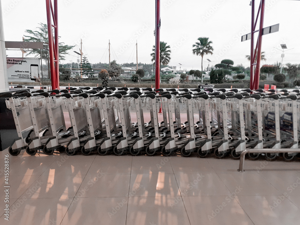 The trolley in town is white. Many trolleys are ready to use ...