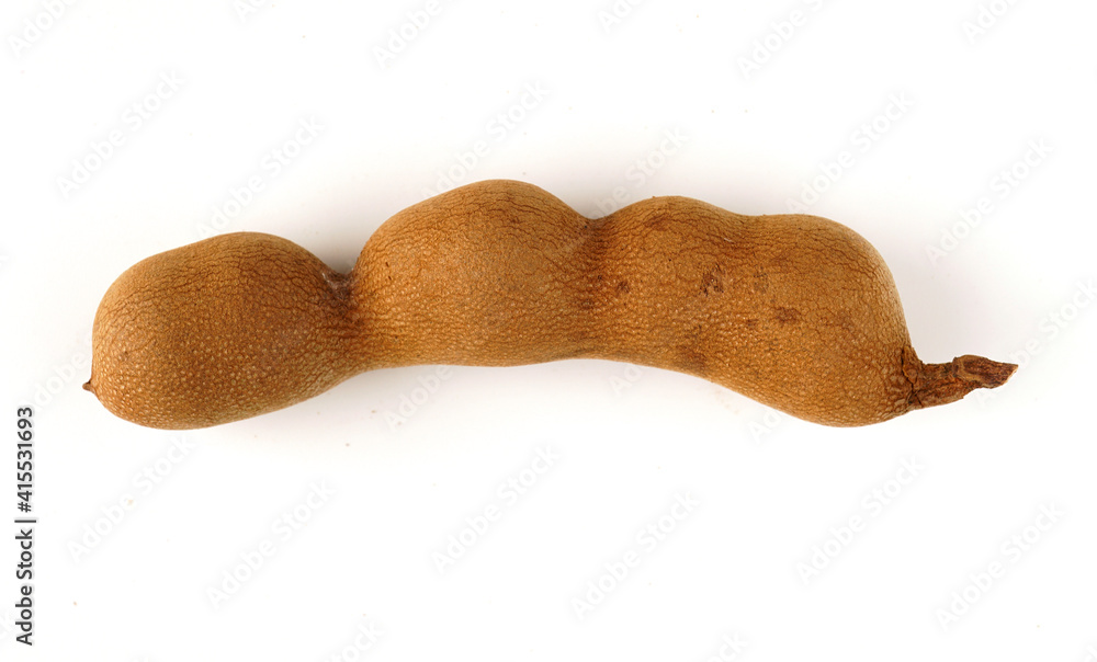 Tamarind tree produces brown, pod-like fruits that contain a sweet ...