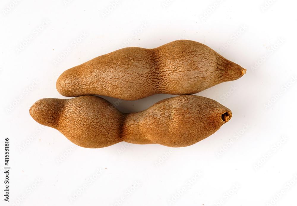 Tamarind tree produces brown, pod-like fruits that contain a sweet ...