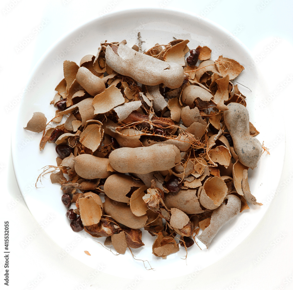 Tamarind tree produces brown, pod-like fruits that contain a sweet ...