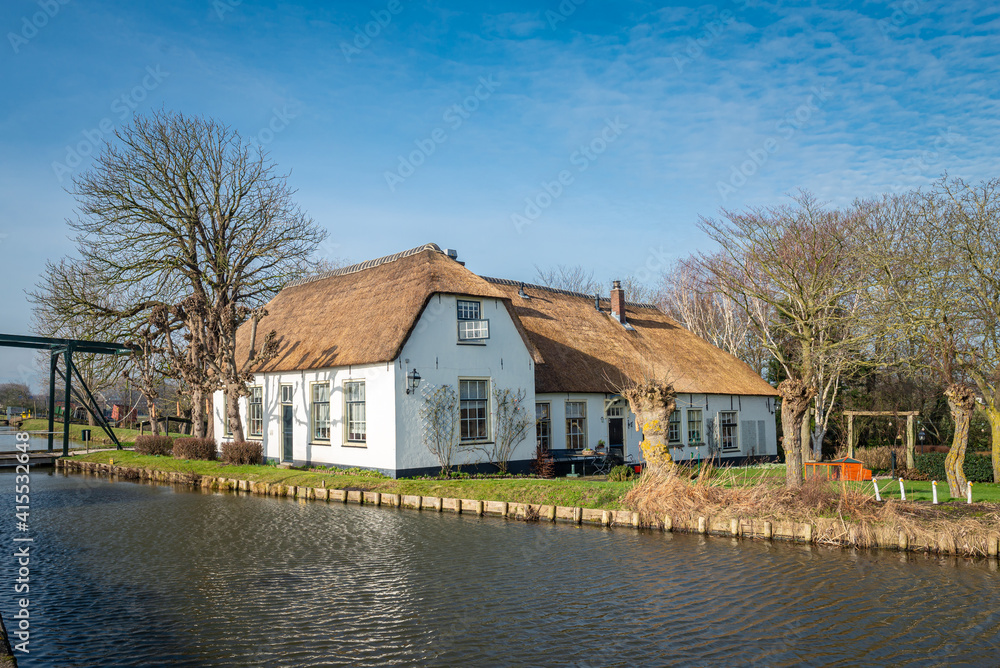 Traditional Dutch farmhouse along a cannel Stock Photo | Adobe Stock