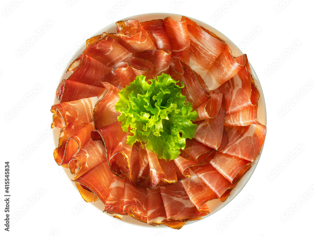 Plate of prosciutto speck ham with a salad leaf, plate of sliced smoked ...
