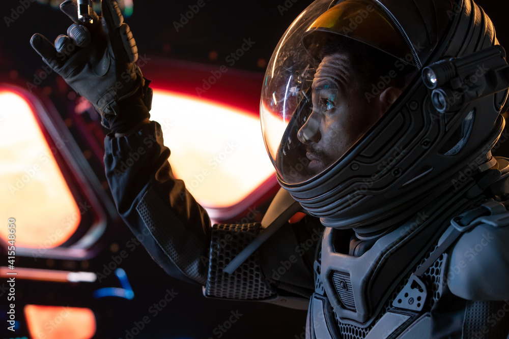 Portrait of African American Black male astronaut inside spaceship ...
