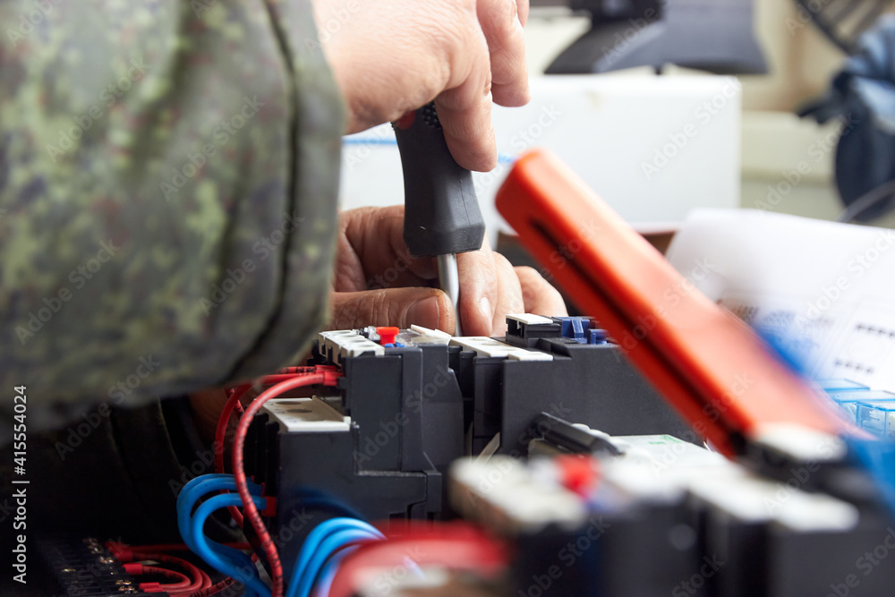 worker assembling contact panel with wired electrical contactor Stock ...