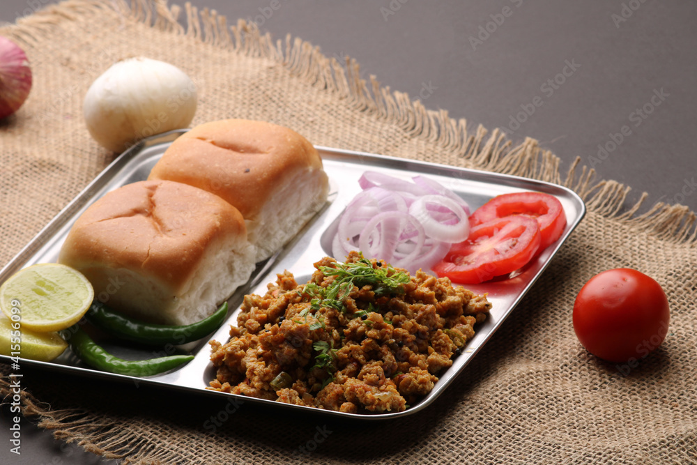 Masala Anda Bhurji or Spicy Indian scrambled eggs with bread or Bun Pav ...