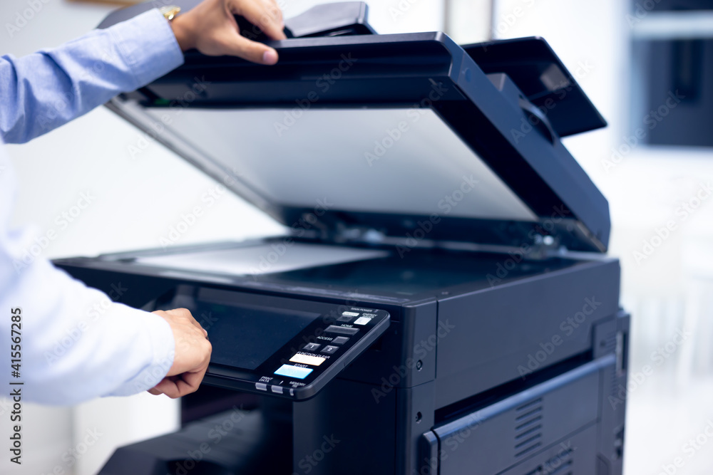 Bussiness man Hand press button on panel of printer, printer scanner ...