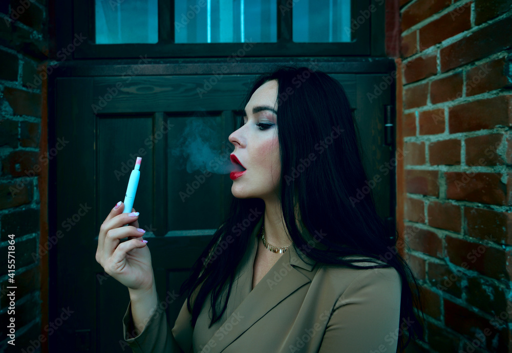 Smoker woman smoking hybrid smokeless cigarette device that uses real ...