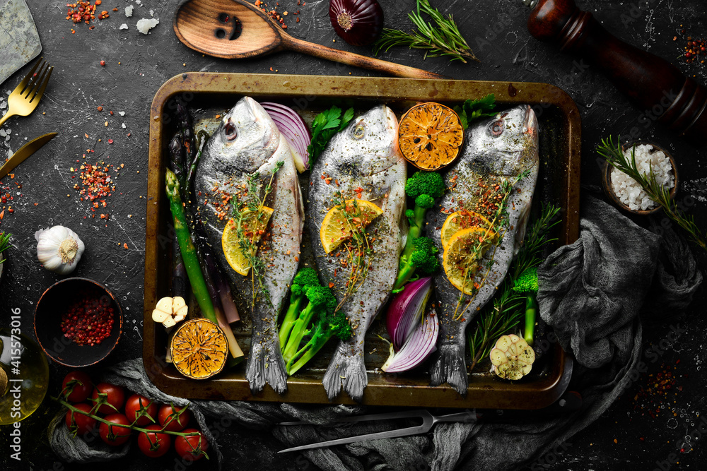 Raw Dorado fish with vegetables in a metal tray. Fish cooking recipe ...