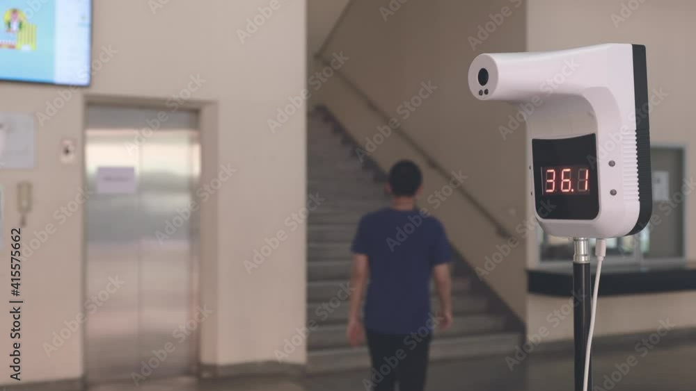 Man approached the forehead thermometer sensor to detect body heat ...