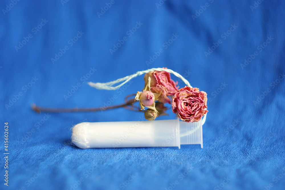 menopause concept. dried red rose lies on a woman tampon. dried rose ...