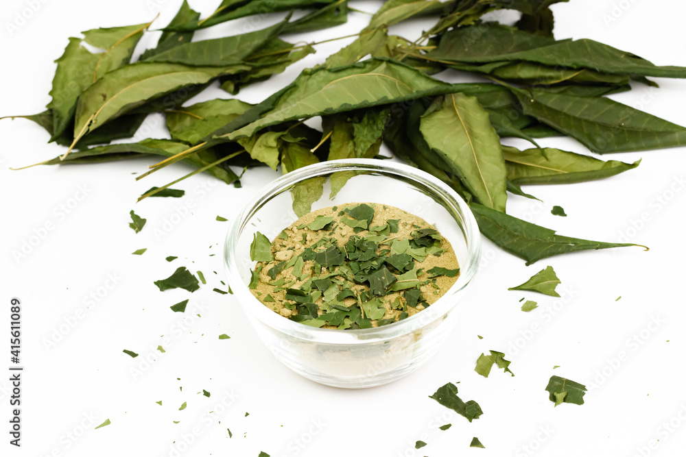 Neem powder in transparent bowl and dried neem leaf isolated on white ...