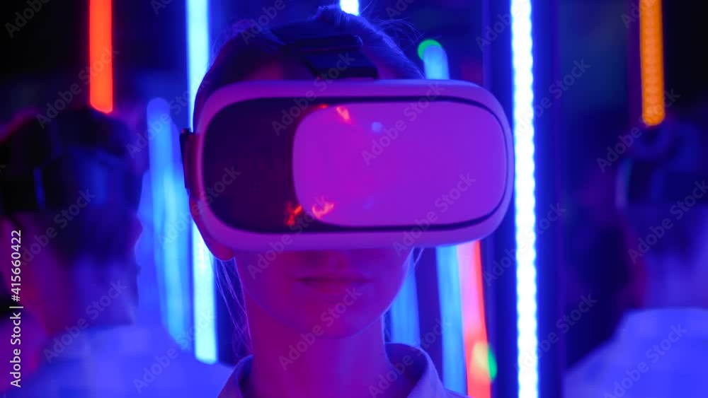 Slow motion: woman using virtual reality headset and looking around at ...