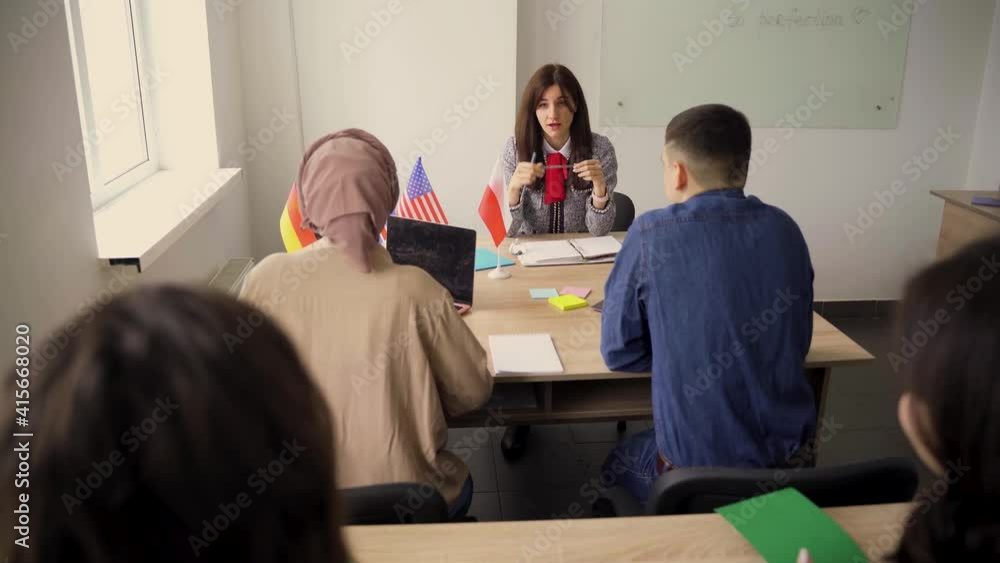Multiethnic students and teacher study foreign languages together in ...