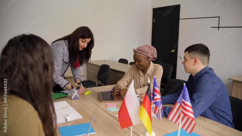 Teamwork. Working in multiethnic group of students. teacher study foreign languages together in ...