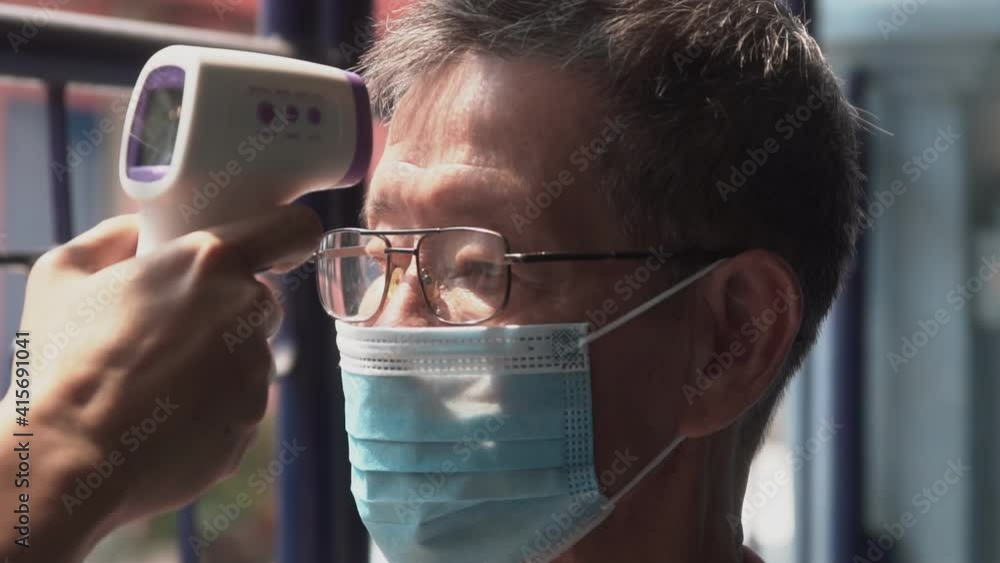 Covid -19 Body temperature measuring for coronavirus. Measures a senior ...