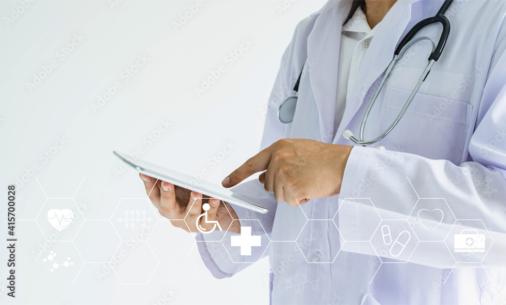 Doctor with stethoscope lies using tablet and white icon medical for ...