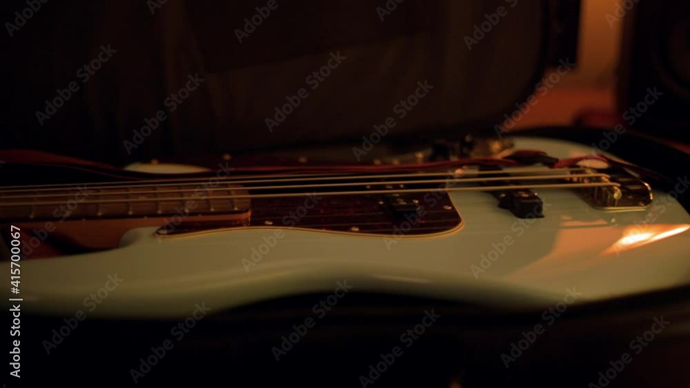 Opening a guitar case with a bass inside. The cameras focus is on the ...