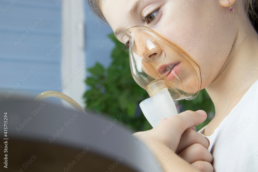 little girl doing inhalation at home with medicines for bronchitis and ...