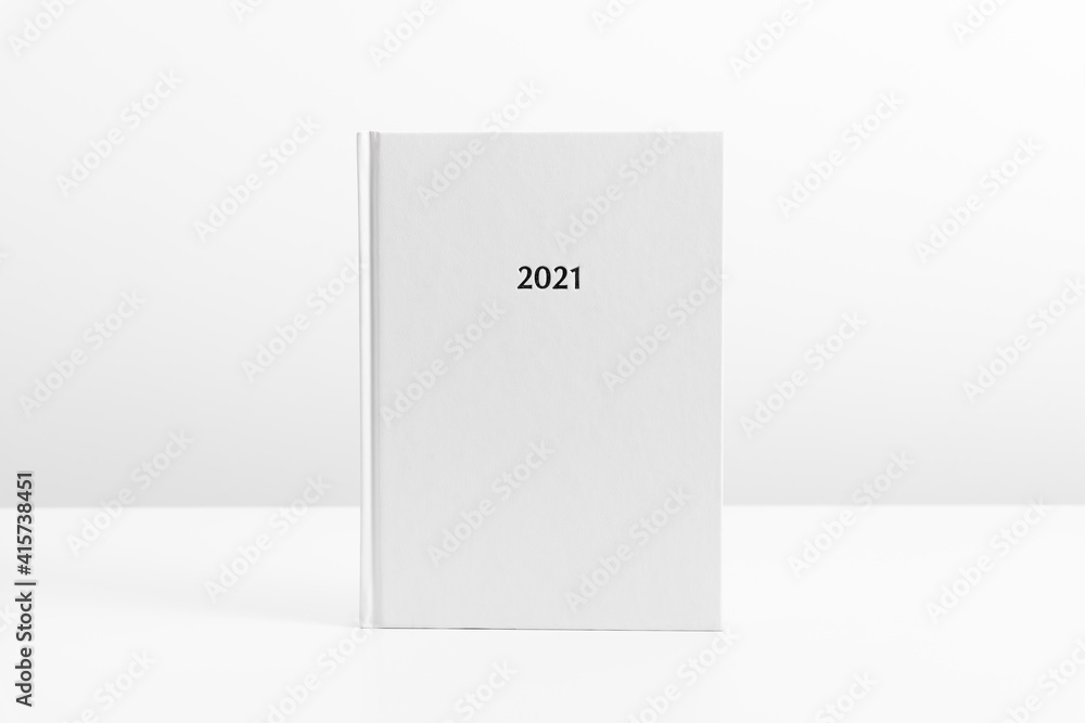 White book mockup, diary for 2021, white table. Front view. Place for ...