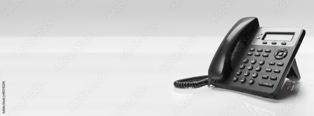 Close up telephone devices at office desk for customer service support ...