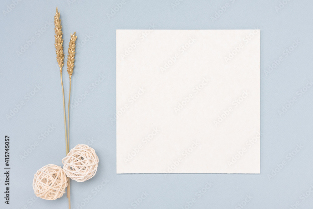 Square invitation card mockup with dried golden ears on a neutral color ...