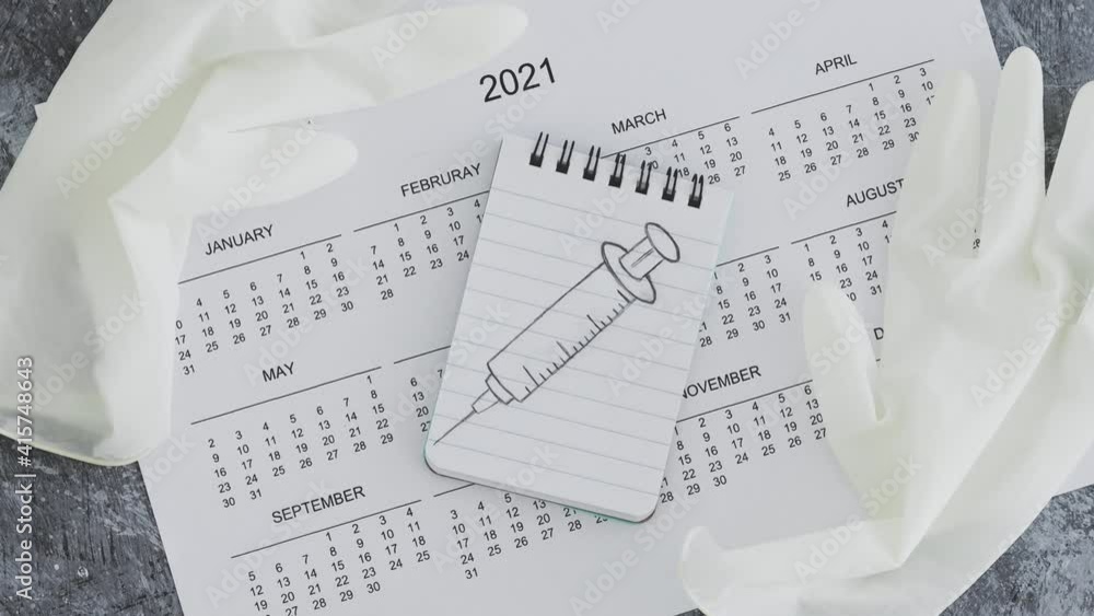 covid-19 vaccine, 2021 calendar with syringe sketch on notepad and ...