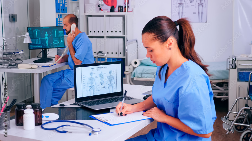 Group of nurses working in hospital office, analysing digital human ...