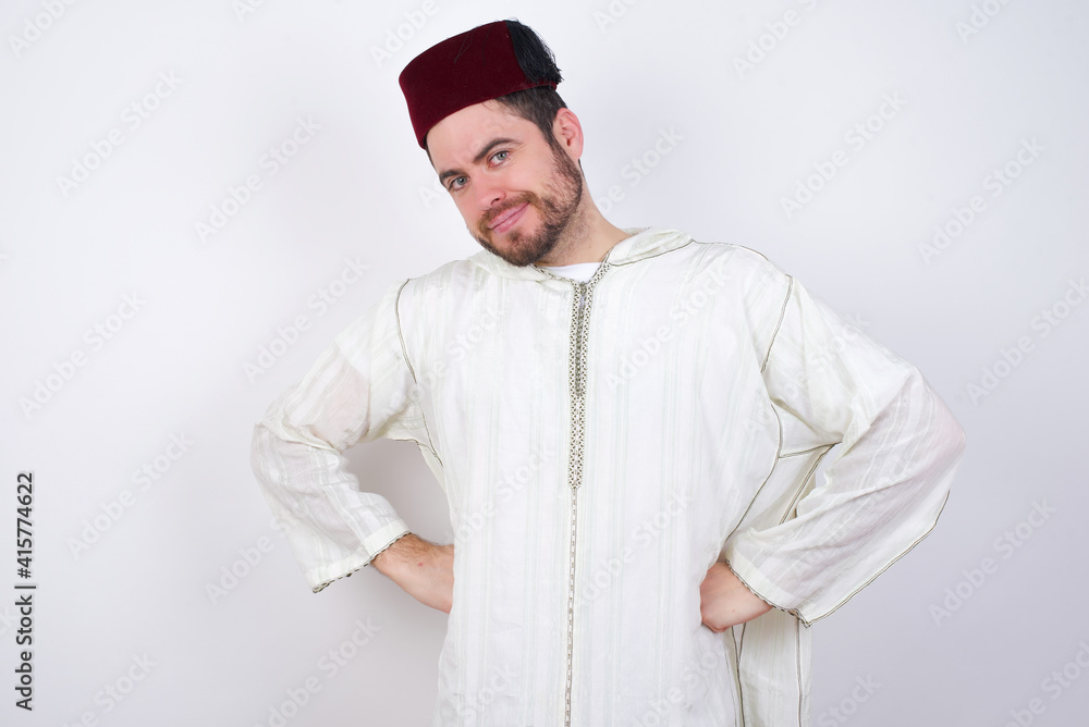 Funny frustrated young handsome Caucasian man wearing Arab djellaba and ...