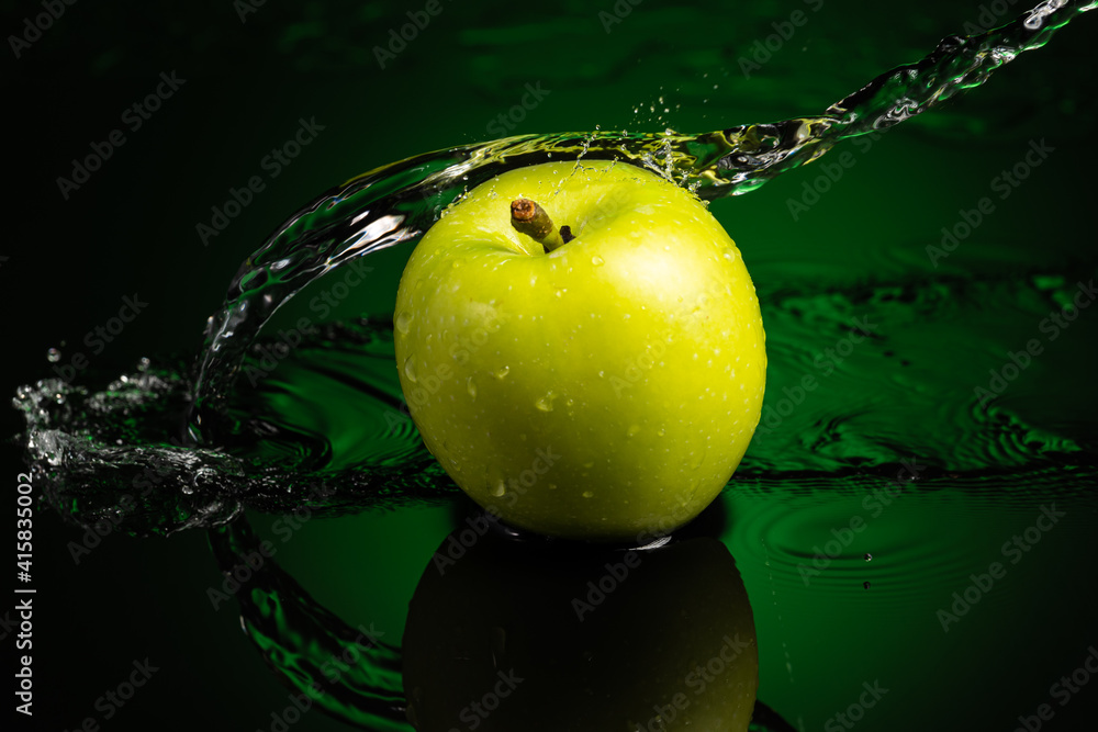 whole green apple with splash and water flow on dark background Stock ...