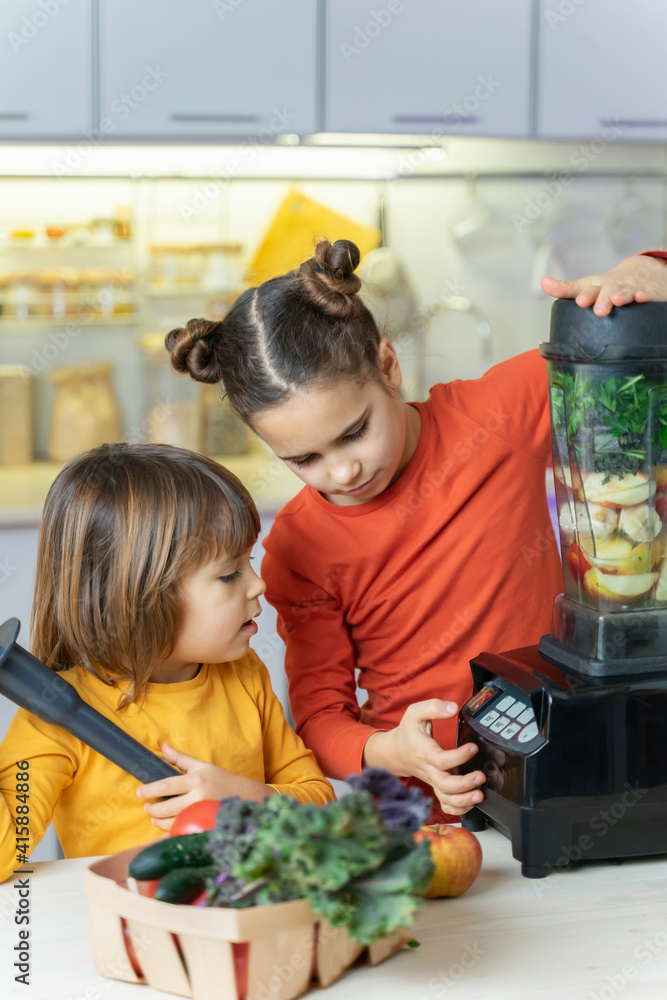 Beautiful Children prepare delicious and useful green cocktail ...