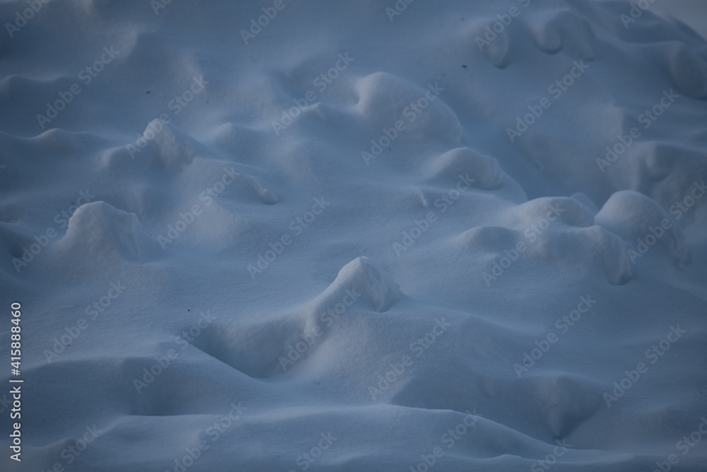 snow landscape made from mounds of snow and snow drifts sunlight ...