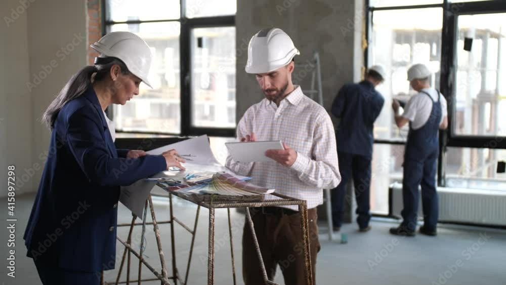 Female engineer taking measurements with ruler and divider benting over ...