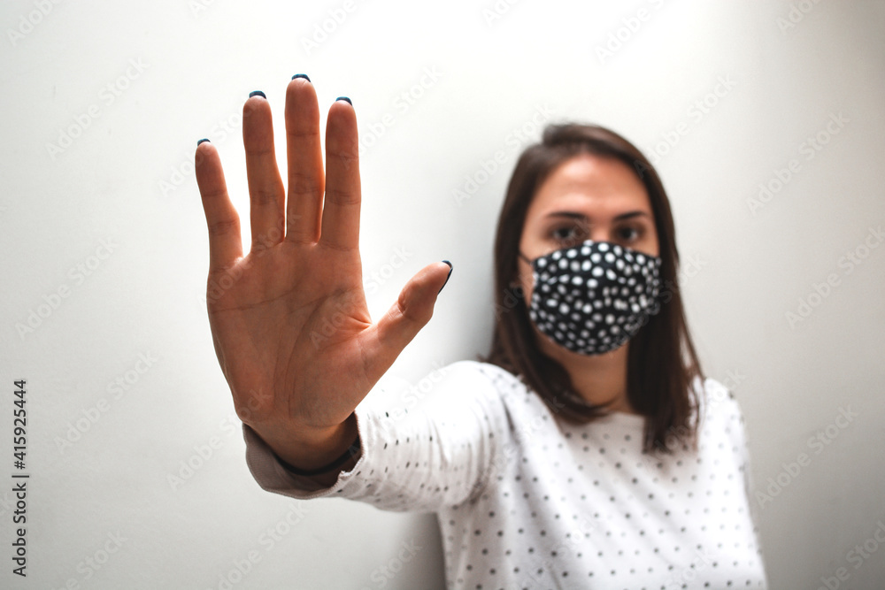 Girl making a stop sign with her hand wearing a face mask Stock Photo ...