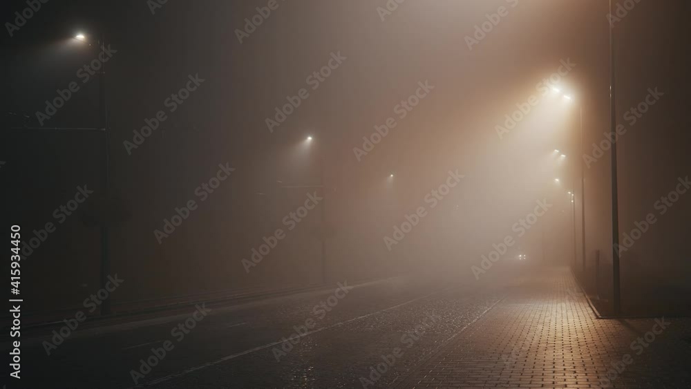 Night walk in empty beautiful city. Cinematic cloudy thick fog ...