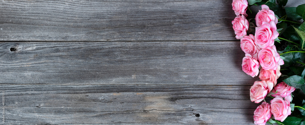 Bouquet of vibrant pink roses placed on weathered wooden planks for ...