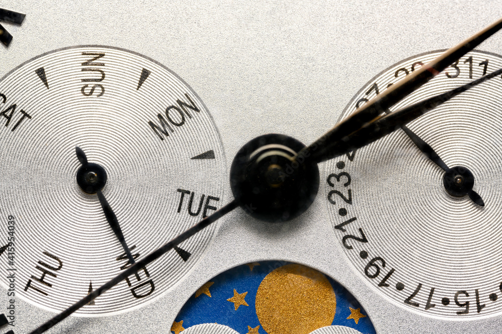 The dial of a hand-held watch with the days of the month, day of the ...