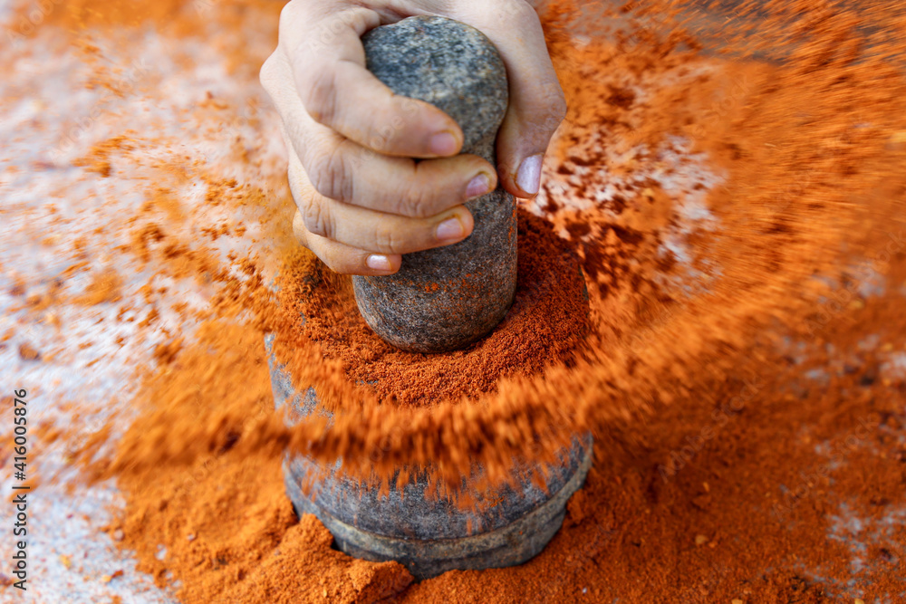 Indian woman hand powdering Indian spices Red chilly , chili paprika ...
