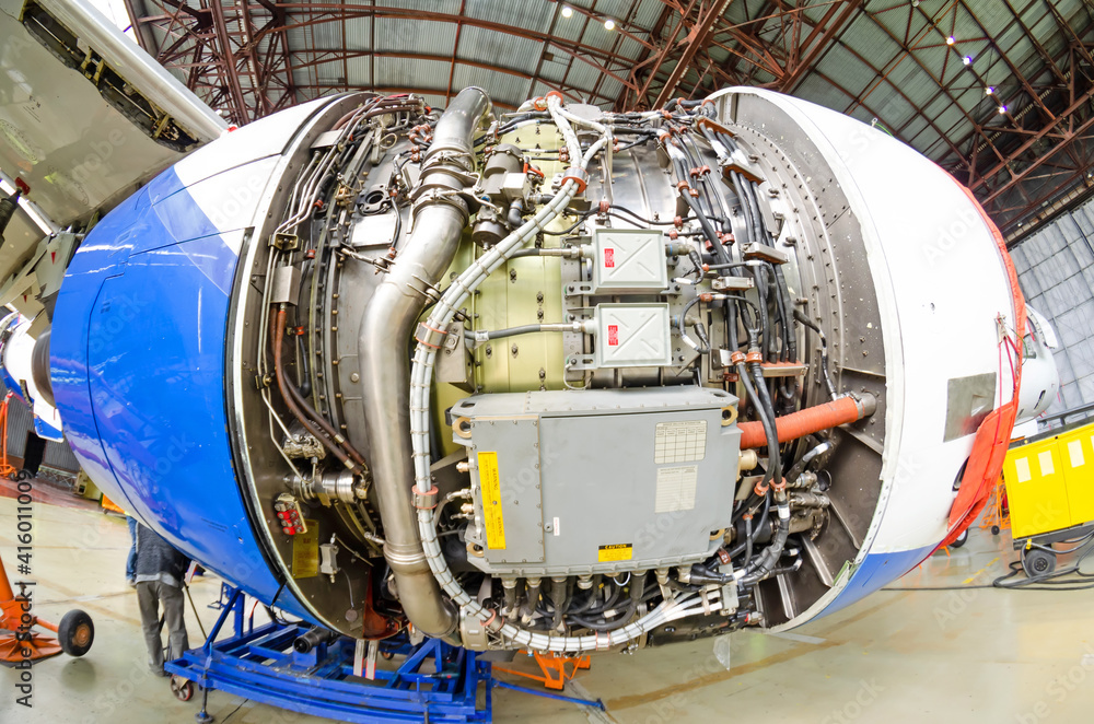 Troubleshooting the engine with an open hood of the aircraft in the ...