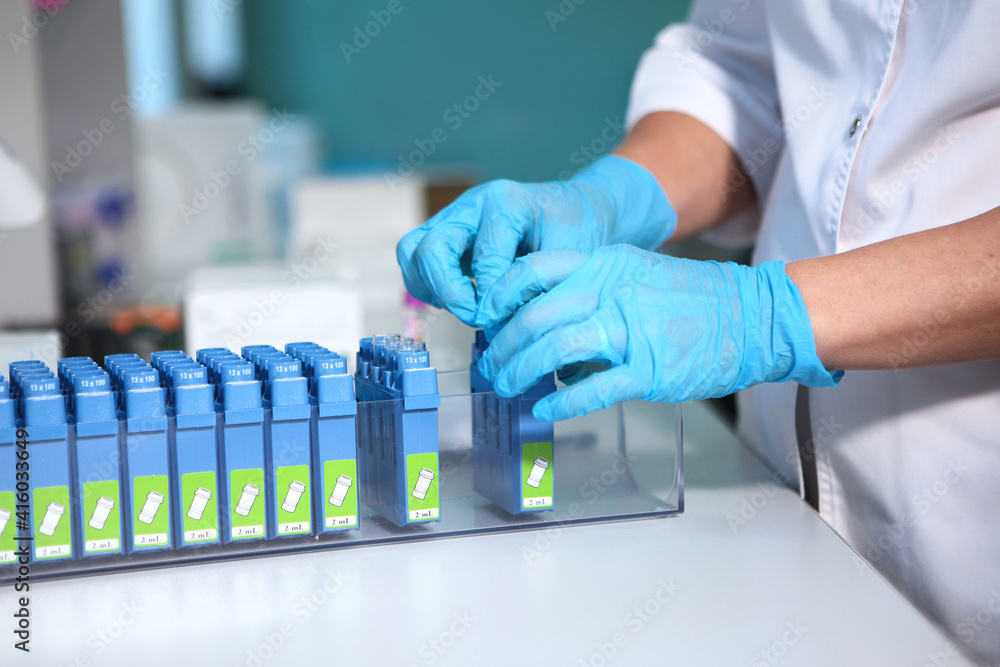 Tripod with many test tubes in the lab.Development of a new vaccine. A ...