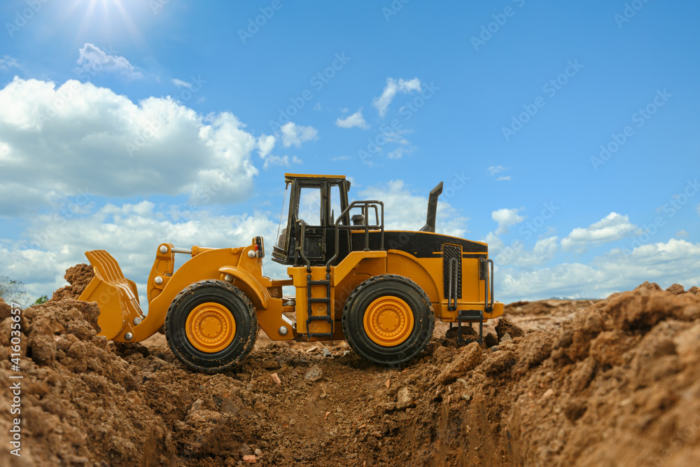 Wheel loader are digging the soil in the construction site on the blue ...