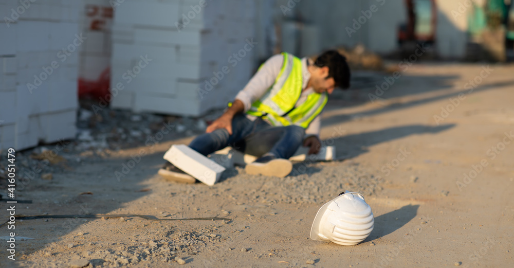 Construction worker has an accident lying on the floor while working in ...