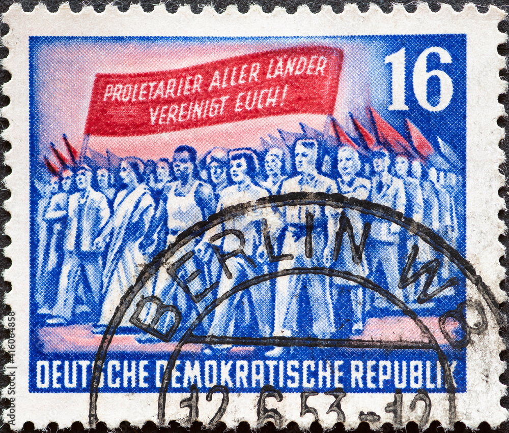 GERMANY, DDR - CIRCA 1953 : a postage stamp from Germany, GDR showing a march. On the 70th ...