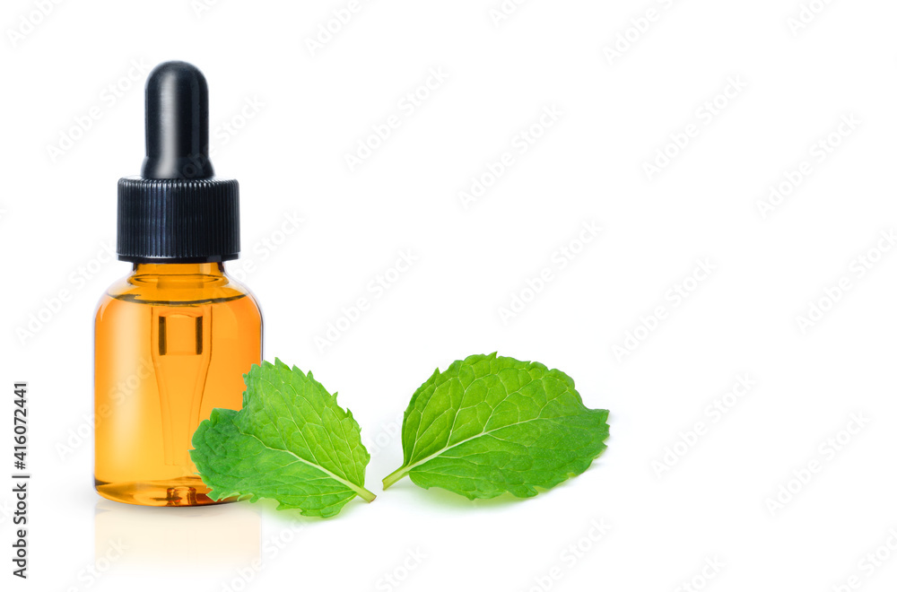 Mint (spearmint) leaves with peppermint essential oil extract in glass ...